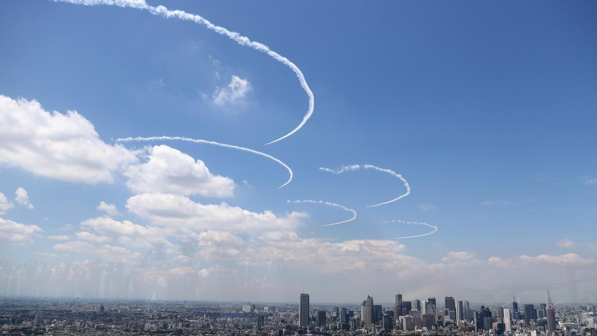 Tokyo Olympics: Five rings up in Tokyo sky as competition gets underway ...